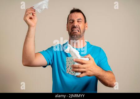 Allergy concept. Man suffers from skin irritation isolated on gray ...