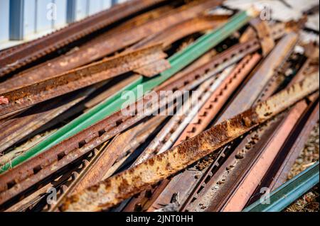 Pile of rusted steel fence posts on the ground Stock Photo - Alamy