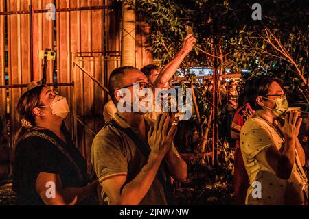 People pray during a ghost month ceremony in Taipei, Taiwan, Wednesday ...