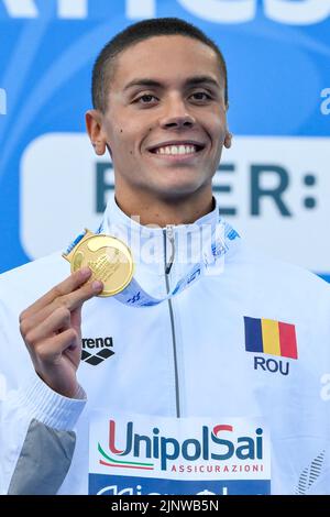 David Popovici of Romania shows the gold medal after competing in the ...