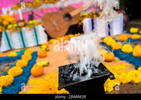 An incense burner is seen smoking at the altar of the dead during the ...