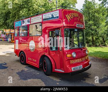Discover Buxton in a small red open-topped tourist bus Stock Photo - Alamy