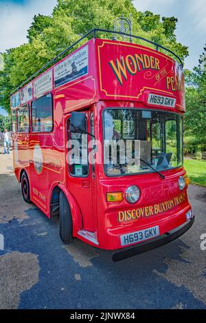 Discover Buxton in a small red open-topped tourist bus Stock Photo - Alamy