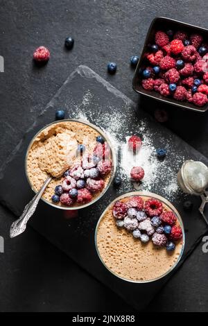 Ryazhenka (fermented baked milk) mousse in glass bowls decorated with ...