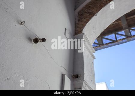 Mechanically operated doorbell on a torsion spring actuated by a wire ...