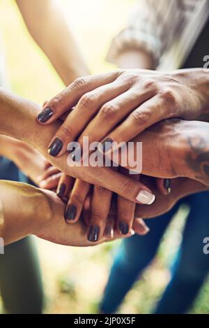 Hands, huddle and solidarity with people outdoor from below on sky for ...