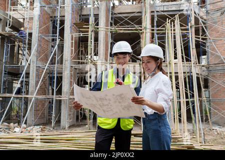 Structural engineer and architect discussing and working with ...