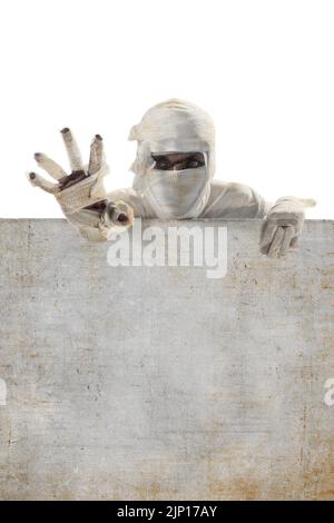 Mummy coming from behind the wall isolated over white background Stock ...
