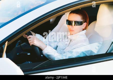 Fashion cyberpunk girl drive a supercar. Red hair woman with futuristic ...