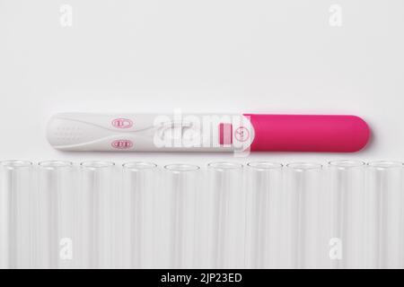 Positive pregnancy test with laboratory test tube. In vitro ...