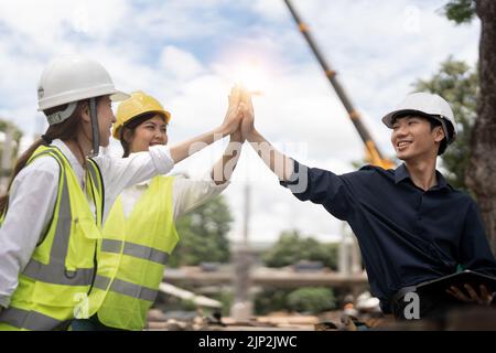 Engineers people join hands to build successful projects. Teamwork ...