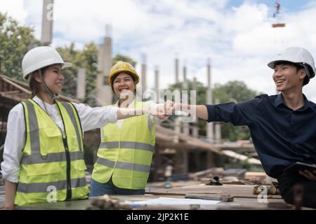 Engineers people join hands to build successful projects. Teamwork ...