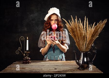 Vintage style portrait of pretty redhead woman with long curly hair ...