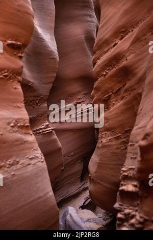A closeup shot of a brown sandy cave with narrow passageway and ...