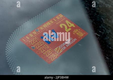 A closeup shot of a vehicle technical inspection sticker in a red color ...