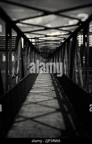 A grayscale shot of a wooden bridge Stock Photo - Alamy