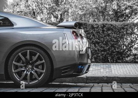 A gray Nissan GT-R parked on the side of a road Stock Photo - Alamy