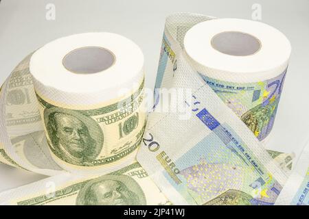 Rolls of bank notes toilet paper on white background Stock Photo - Alamy