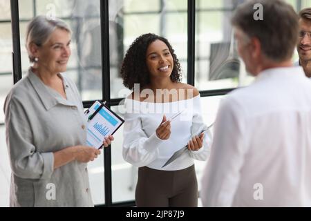 Conversation between managers and employees in the office Stock Photo ...