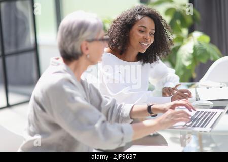Software development team discussing algorithms on computer screen in ...