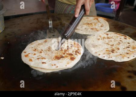 cooking roti chapati on a big cooking pan Stock Photo - Alamy