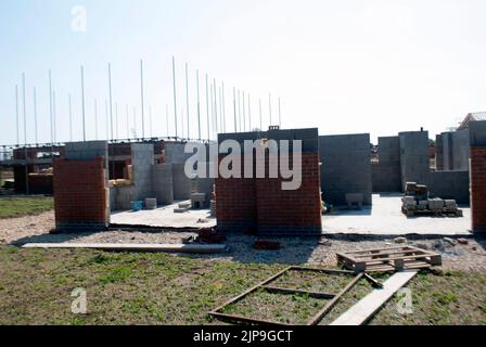 Partially constructed house surrounded by scaffolding on building site ...