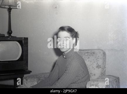 Television in the 1950s. A young woman is pictured beside a typical 50s ...