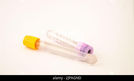Yellow, purple colored blood test tubes on the isolated white ...