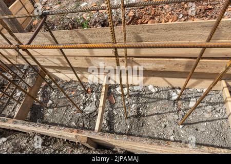 Reinforcement covered with earth during the collapse of the formwork ...