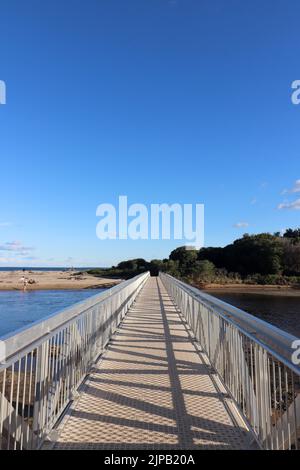A modern pedestrian bridge over Crooked river at Gerroa South Coast NSW ...