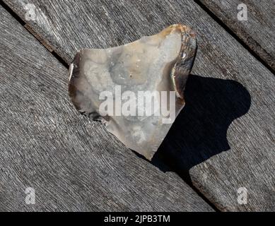Example of flint-knapping; a larger piece of flint is struck along ...