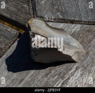 Example of flint-knapping; a larger piece of flint is struck along ...