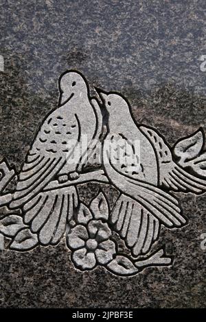 White doves depicted on a memorial monument in a cemetery Stock Photo ...