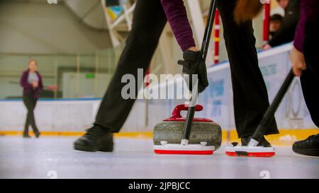 Curling training - leading granite stone on the ice Stock Photo - Alamy
