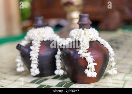 Jasmine flowers decorated on water clay jug or known as kendi as a ...