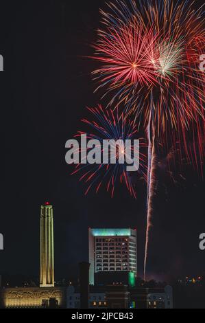 A vertical shot of exploding red fireworks in the sky at night Stock ...