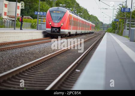 A red DB train arriving at a station in Geilenkirchen, Germany Stock ...