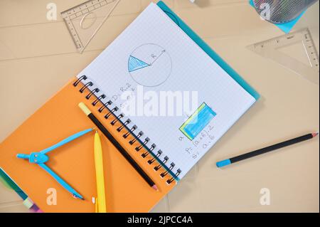 Flat lay of a copybook with geometry examples for solving in primary ...
