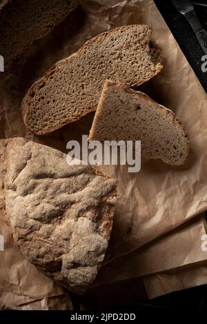 Low key food photography. Black rustic bread on dark background Stock ...