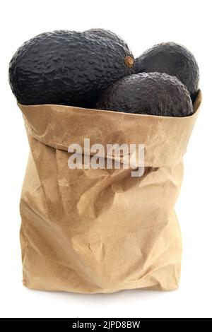 Paper bag with fresh avocado hass in the box on wooden dark background ...