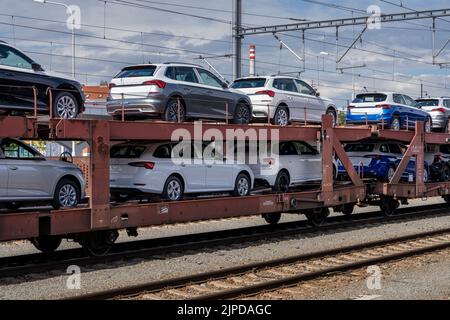 The process of transportation of cars by rail on special wagons. Pilsen ...