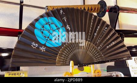 A closeup of a fan with the family crest of a Japanese warlord sold in ...