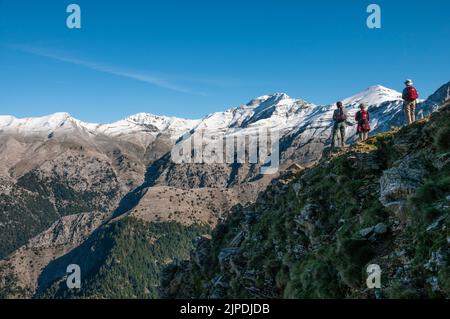Walkers on Niva hill looking towards the Pendadhaktilo ridge, watershed ...