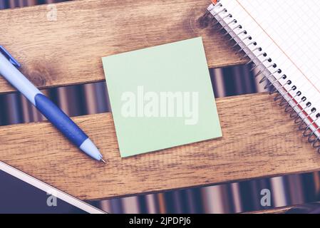 Man With Pen Writing Recent Updates On Notebook On Desk With Notes And ...
