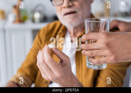african american man with pill and glass of water Stock Photo - Alamy