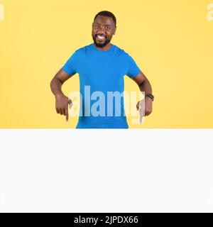 bearded man yellow mockup poster in hand blue background Stock Photo ...