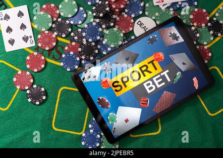 Smartphone with poket table on screen, playing cards and chip cards on ...