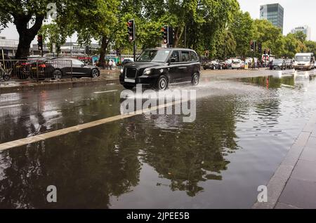 Car drives through flooded Euston Road in Central London after rain ...