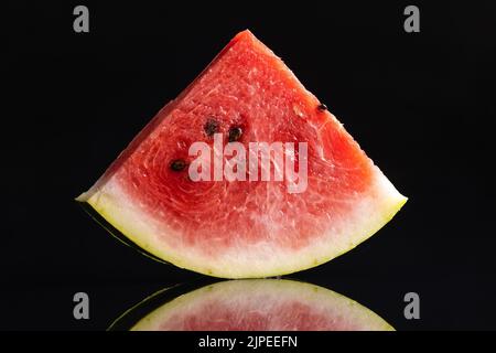 Slices of ripe watermelon on a black stone background Stock Photo - Alamy