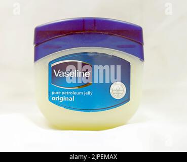 Vaseline petroleum jelly. Plastic tub / container with blue lid against ...